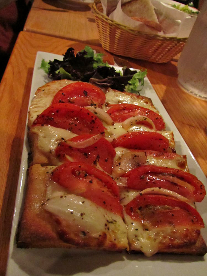 This flatbread looks like what Italian grandmothers would make if they decided to create something between pizza and heaven.