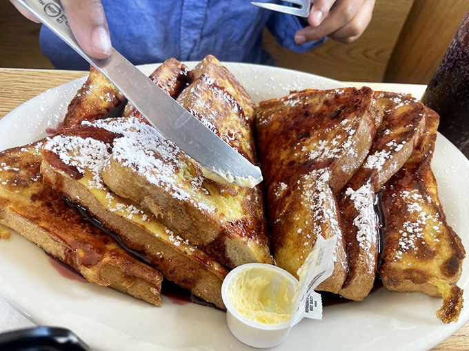 French toast that's achieved celebrity status in my mind—golden, custardy interior with a dusting of powdered sugar that makes syrup the perfect supporting actor.