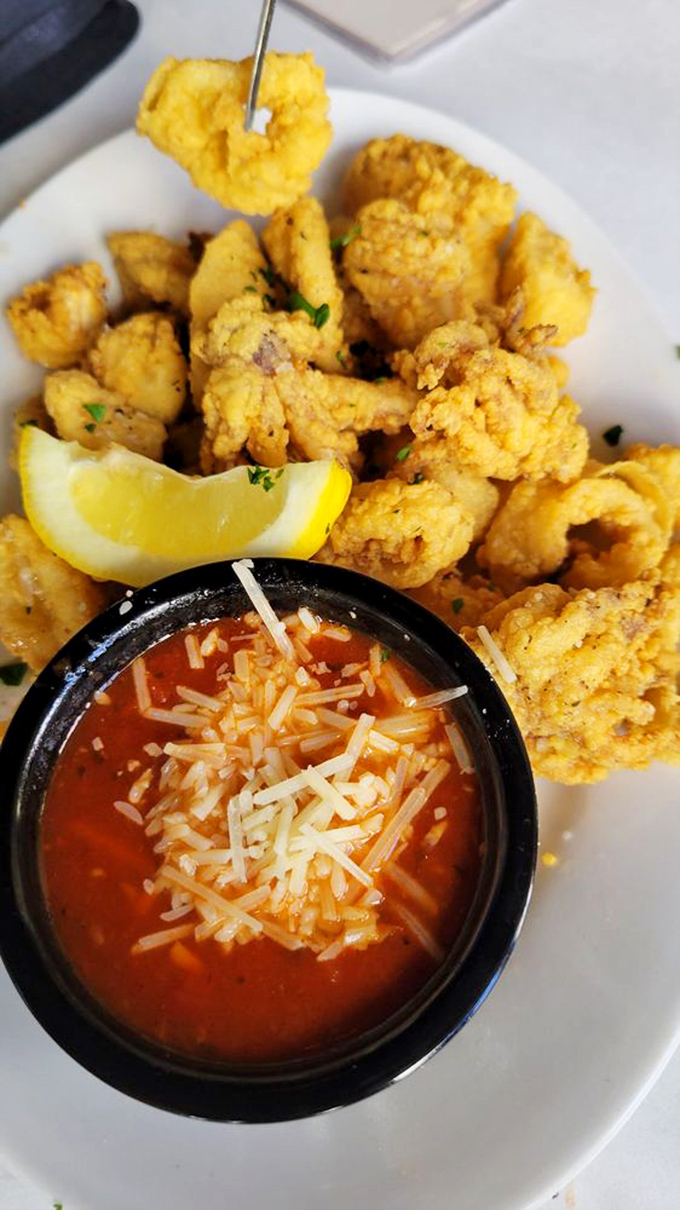 Golden-fried calamari that achieves the textural impossible: crispy exterior giving way to tender seafood that never crossed into rubber band territory.