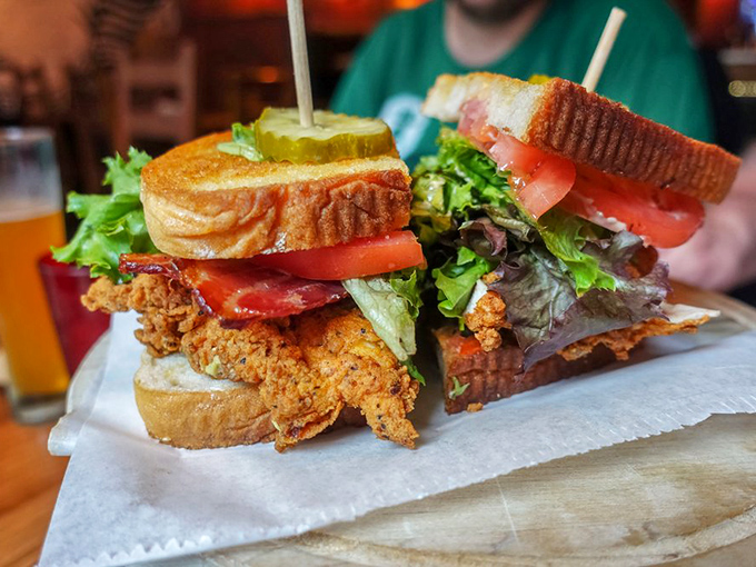 Architecture matters in sandwiches too. This towering creation balances crispy chicken, fresh veggies, and toasted bread in perfect structural harmony.
