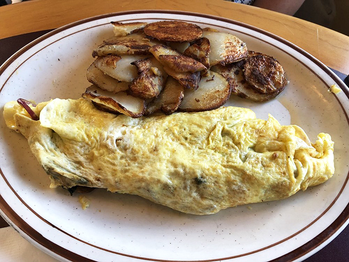 Perfectly executed simplicity&mdash;this omelet's golden exterior gives way to a tender interior filled with savory delights. Those potatoes deserve their own fan club.