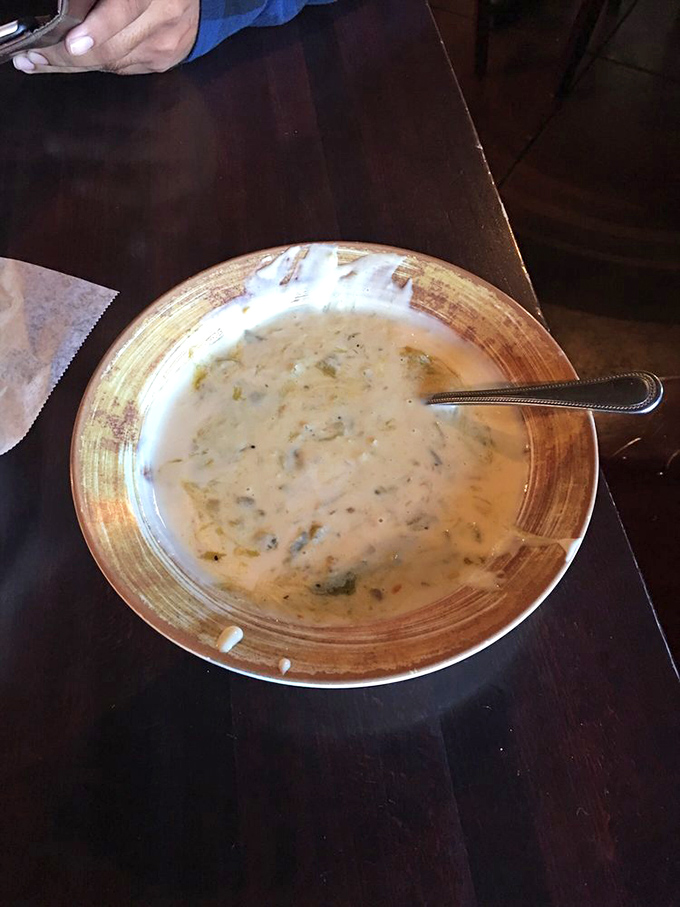 This isn't just cheese dip – it's a silky, speckled pool of comfort that transforms ordinary tortilla chips into vehicles of joy.