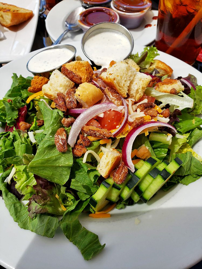 Even salads get the royal treatment here. Fresh greens become the perfect canvas for smoky bacon bits and homemade croutons.