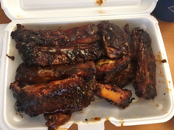 These ribs have the telltale pink smoke ring that separates barbecue artists from pretenders. Each one is a masterclass in patience and fire management.