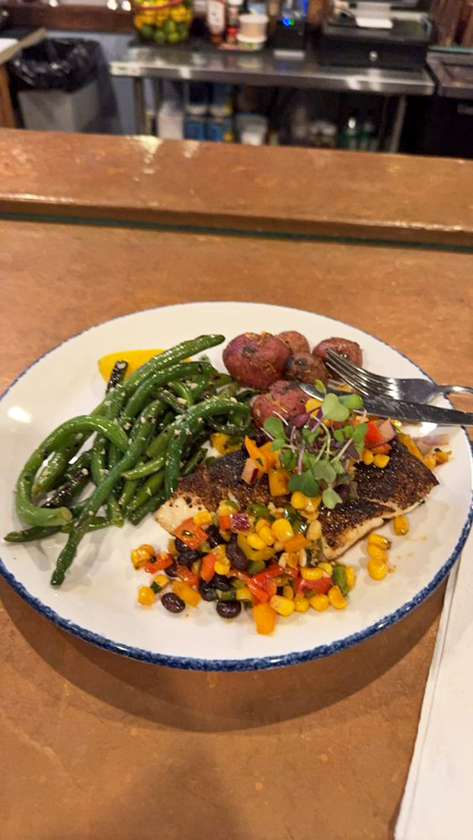 Halibut gets the royal treatment with green beans and a colorful corn salsa. This isn't just seafood; it's a celebration of coastal bounty.