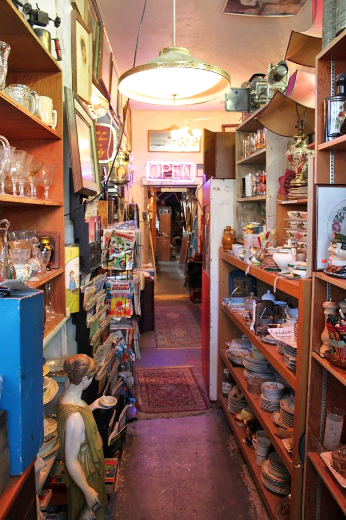 Narrow passages lead to wider wonders, with vintage dishware and collectibles creating a tunnel of time travel for the determined treasure hunter.