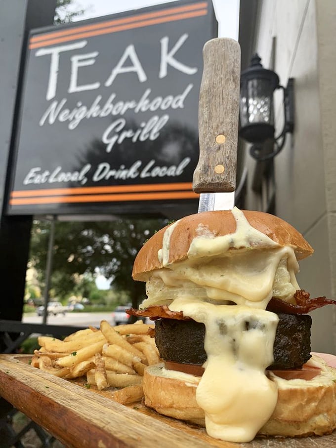 This isn't just a burger &ndash; it's a statement piece. The knife isn't a serving suggestion; it's structural support for this towering masterpiece.