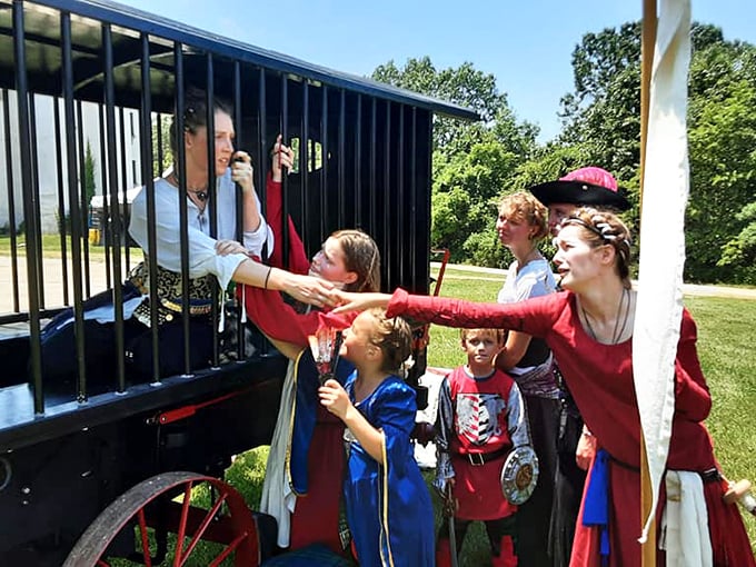 Medieval entertainment in full swing! Nothing says "authentic experience" like watching children try to free someone from ye olde jail cart.