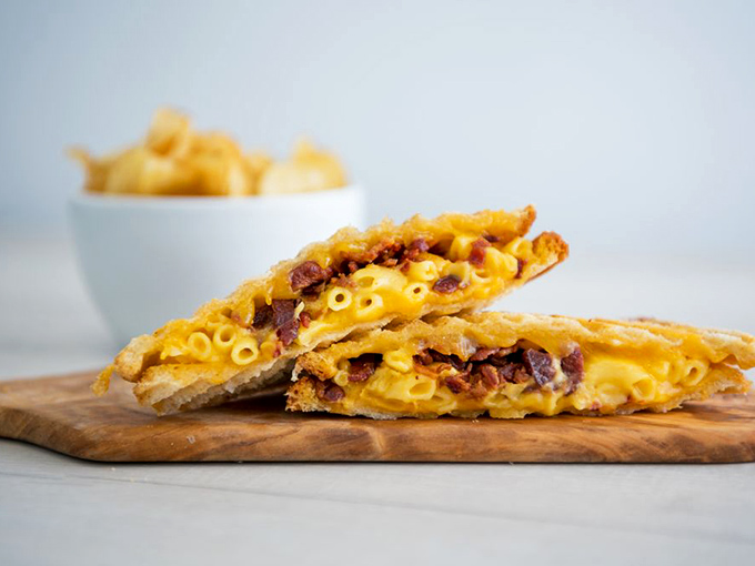 Mac and cheese that's had an existential crisis and emerged stronger, wiser, and studded with bacon. Comfort food that's gone to therapy and come back with confidence.