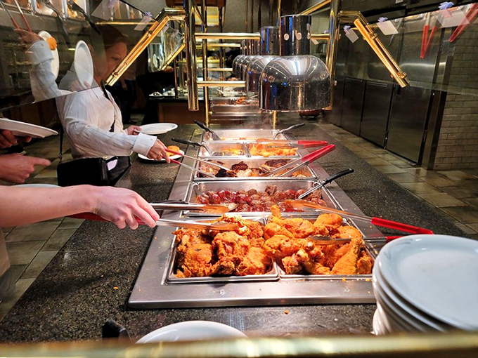 The fried chicken station, where pieces of golden-brown perfection await their fate. Your cardiologist would disapprove, but your soul will sing with joy.
