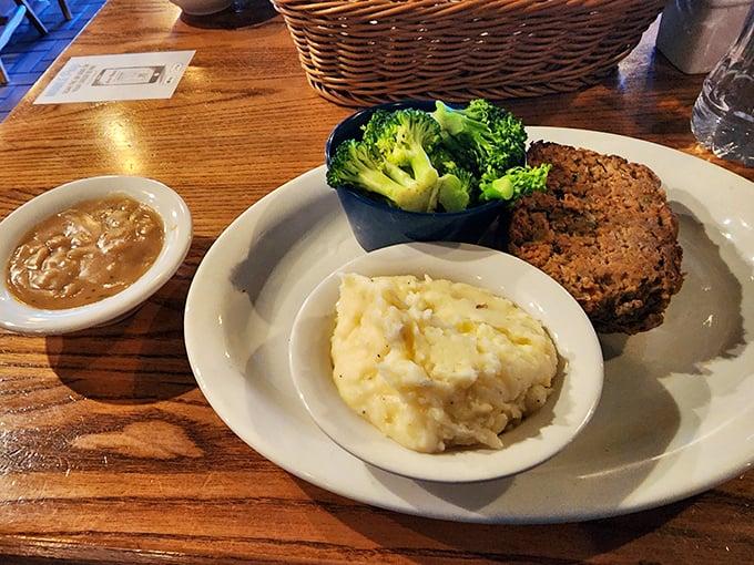 Meatloaf that would make your mother jealous, flanked by cloud-like mashed potatoes and broccoli pretending to make this a balanced meal.