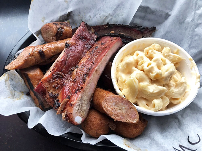 A barbecue United Nations on one tray. Brisket, sausage, pulled pork, and hush puppies creating an international summit of smoke and spice.