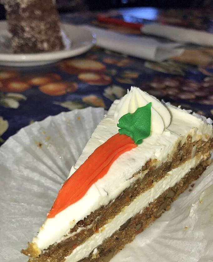 The cross-section reveals the holy grail of carrot cake texture&mdash;moist crumb, visible carrots, and cream cheese frosting that's somehow both rich and light.