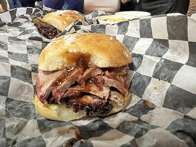 This isn't just a sandwich; it's an architectural marvel of smoked meat engineering that requires both hands and zero shame.