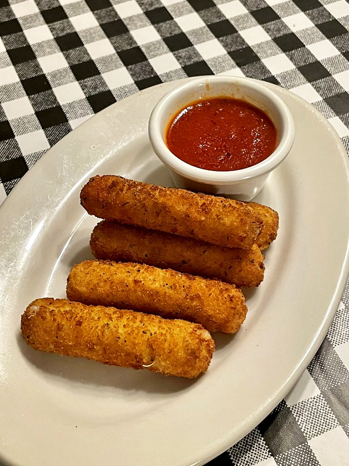 Golden-brown mozzarella sticks with that perfect cheese pull. The marinara dipping sauce deserves its own fan club and commemorative t-shirt.
