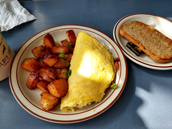 The omelet-to-potato ratio here strikes breakfast perfection&mdash;golden eggs on one side, crispy home fries on the other, happiness throughout.