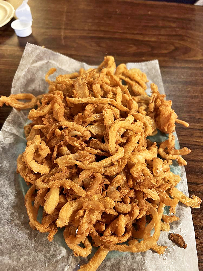 Crispy, golden onion rings piled high like delicious edible jewelry. These aren't afterthoughts&mdash;they're supporting actors deserving of their own standing ovation.