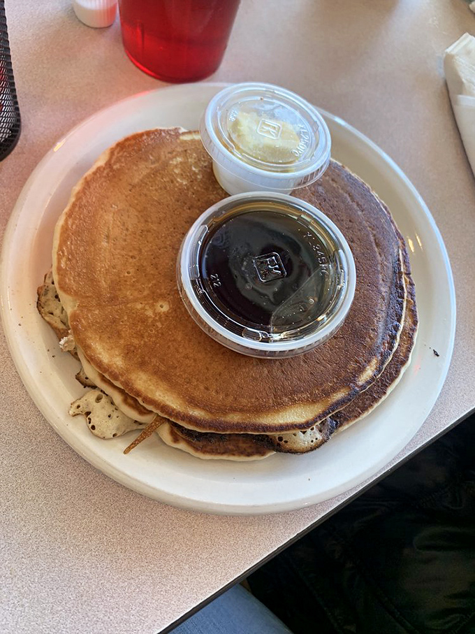 These pancakes aren't just breakfast, they're an event. Golden-brown discs of joy with butter and syrup standing by for their supporting roles.