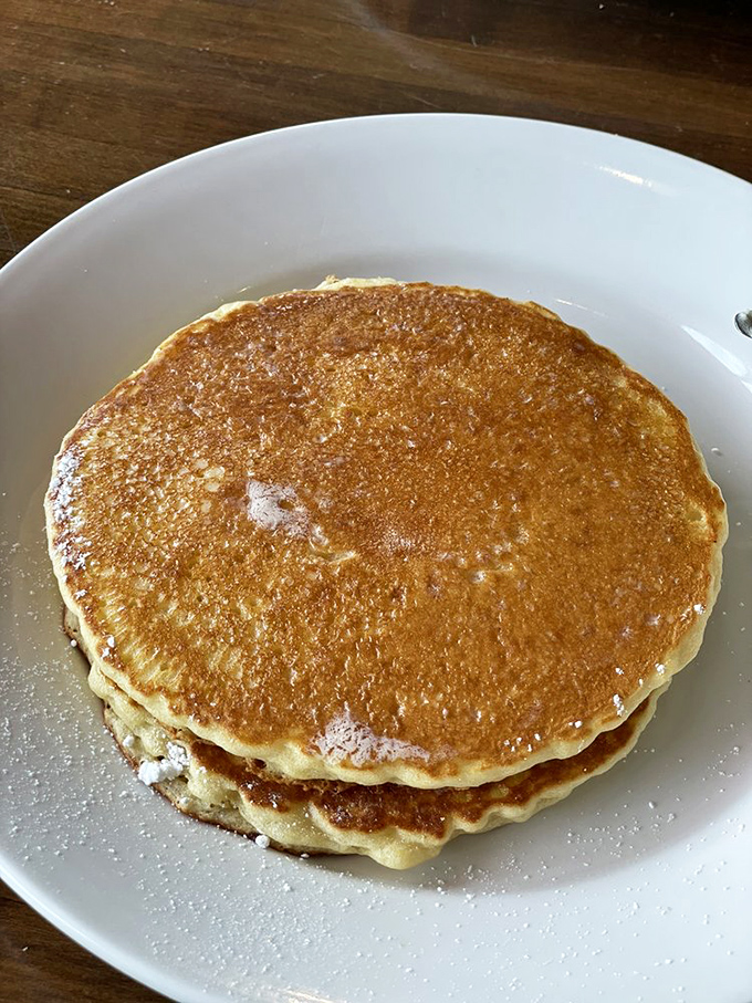 These aren't just pancakes; they're edible gold medals for surviving another week. Perfect golden-brown discs waiting for their syrup waterfall moment.