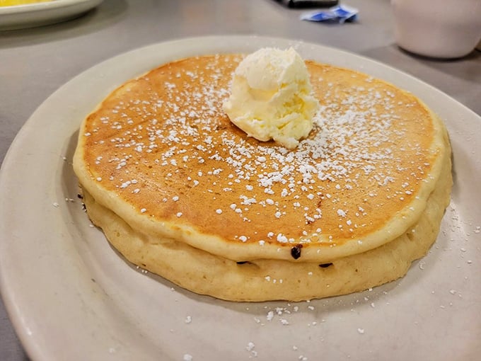 Pancakes so perfectly golden they belong in Fort Knox. That dollop of butter melting on top is performing a slow dance of deliciousness.