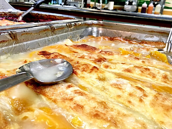 Peach cobbler bubbling with sweet promise. That golden crust has absorbed generations of Southern dessert wisdom.