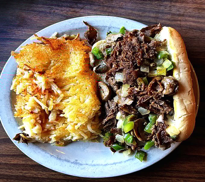 The Philly Cheese Steak brings East Coast flair to Iowa farmland, with tender beef nestled alongside hash browns that could make a potato proud.