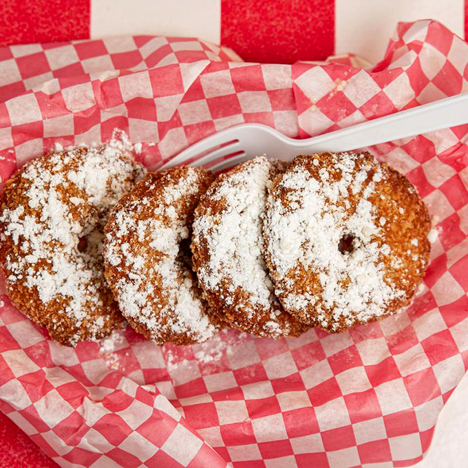 Pineapple rings dusted with powdered sugar—because sometimes dessert should masquerade as a side dish. No one's complaining.