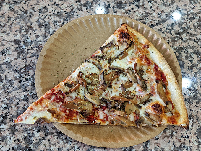 The pizza steak sitting alongside regular pizza creates a carb summit that would make any nutritionist weep and any food lover rejoice.