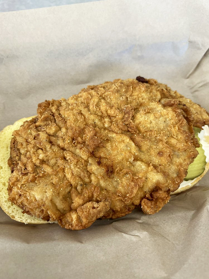 Indiana's iconic pork tenderloin, fried to golden perfection. The bun is merely a suggestion&mdash;a humble platform for this breaded masterpiece.