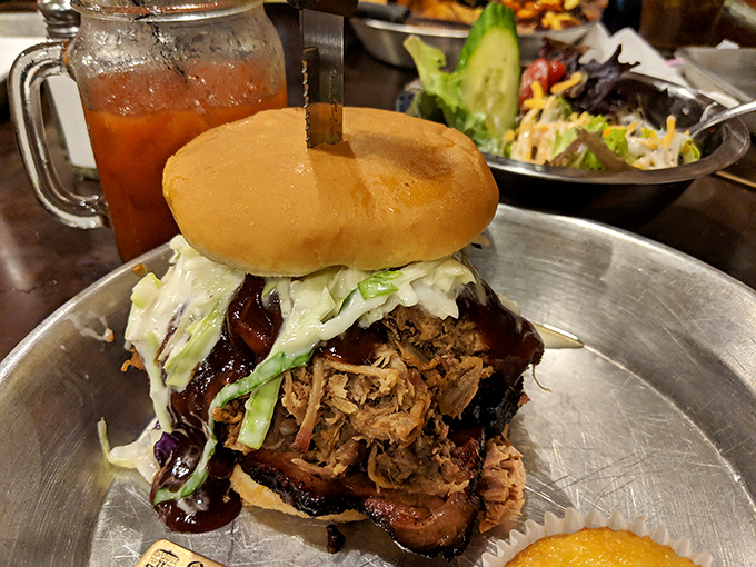 This isn't just a sandwich; it's an engineering marvel. Pulled pork, slaw, and sauce on a bun that somehow contains this beautiful mess of flavor.