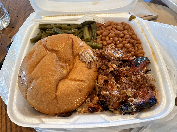Pulled pork that doesn't need to be pulled—it surrenders willingly. Those beans and greens aren't just sides, they're supporting actors deserving their own award.