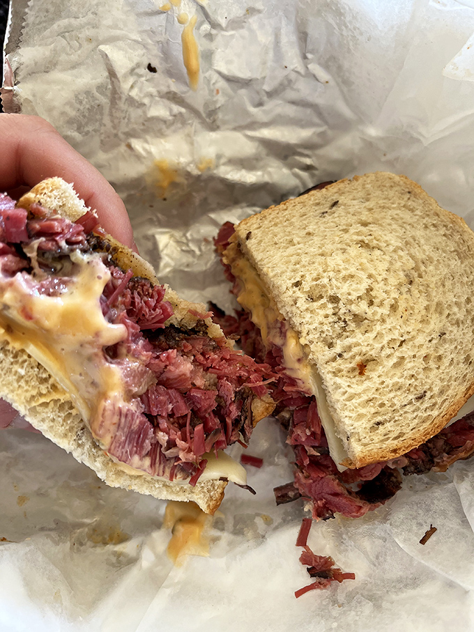 The money shot that launched a thousand cravings. Jake's Reuben cross-section reveals the perfect meat-to-bread ratio that sandwich dreams are made of.