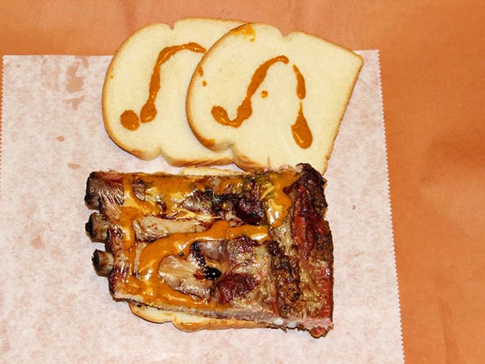 The rib sandwich arrives with that signature sauce drizzled like edible modern art&mdash;Jackson Pollock would approve of both the presentation and flavor.