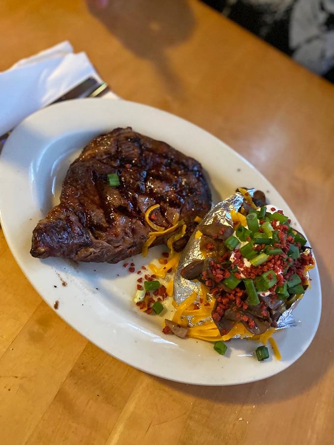 The steak arrives like an old friend who knows exactly what you need - perfectly seared protein with a potato dressed to impress.