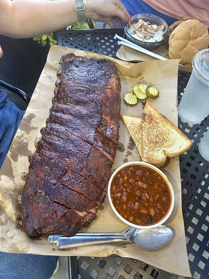 Barbecue plated with the simplicity it deserves. Toast, pickles, beans&mdash;just enough supporting actors to let the star shine.