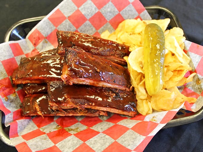 Ribs glistening with sauce like they just stepped out of a barbecue fashion magazine. That pickle isn't garnish – it's necessary acid balance.