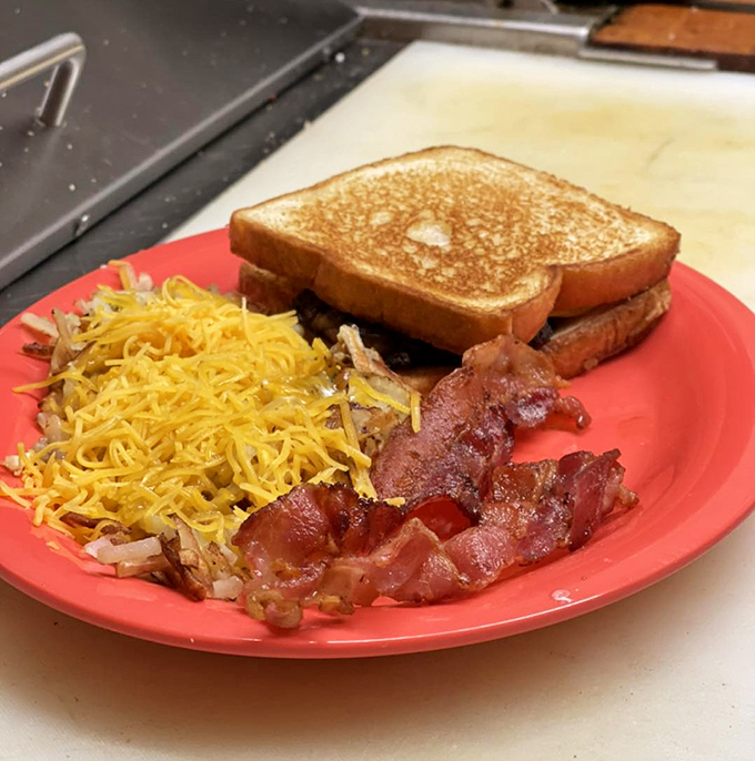Breakfast architecture at its finest—crispy hash browns, perfectly browned toast, and bacon that somehow manages to be both crisp and chewy in all the right places.