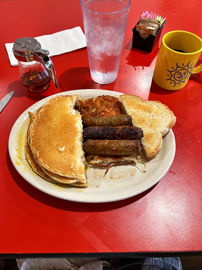 The breakfast sandwich that broke Instagram—pancakes playing the role of bread while sausage and hash browns steal the show.