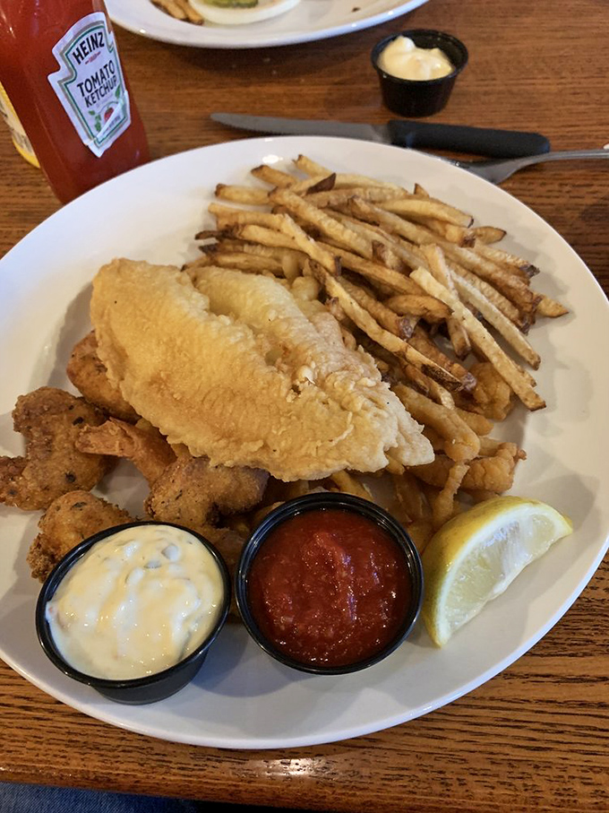 Catfish fingers stacked like delicious Jenga pieces, accompanied by sides that make you forget you're 800 miles from New Orleans.