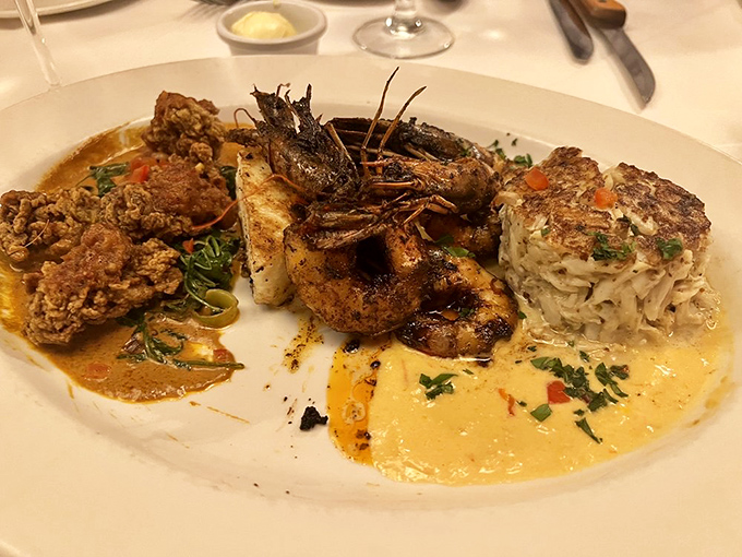 Seafood and steak join forces in this plate where Gulf crab meets beef in a buttery alliance that would make diplomats jealous of its perfect harmony.