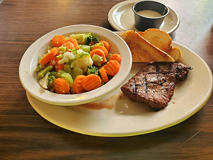 Simple pleasures done right: a perfectly grilled sirloin, vibrant vegetables, and Texas toast. Sometimes happiness is that straightforward.