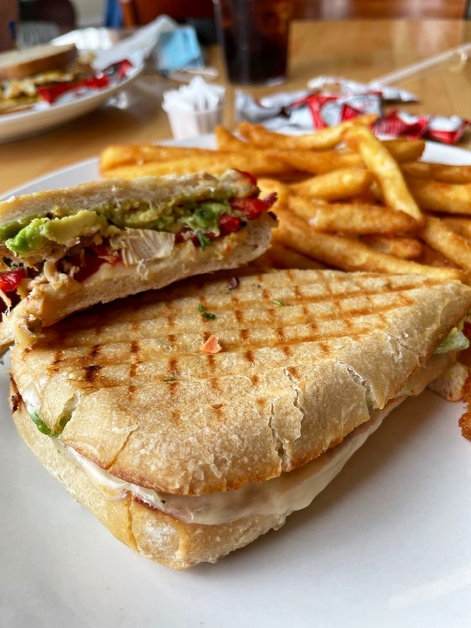 This sandwich isn't just pressed; it's been convinced to reveal all its flavor secrets. The perfect marriage of crispy exterior and melty interior.