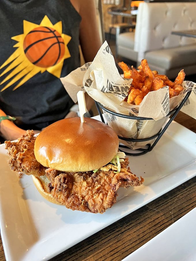 The fried chicken sandwich &ndash; where Southern comfort meets Midwestern hospitality, with sweet potato fries that deserve their own fan club.
