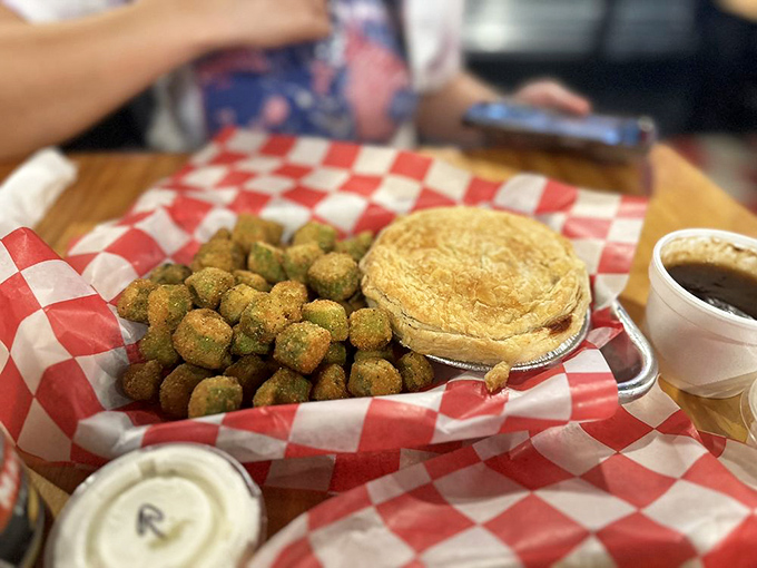 The savory steak pie sits proudly next to fried okra&mdash;a delicious cultural handshake between British tradition and Southern comfort.