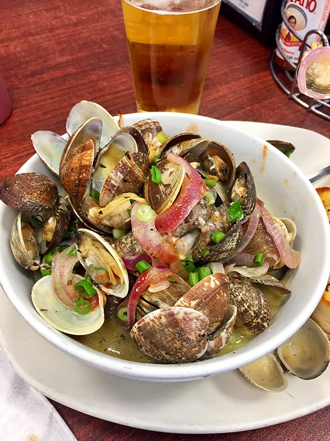 Steamer clams bathing in aromatic broth with a cold beer standing by&mdash;nature's perfect partnership since the dawn of seafood.