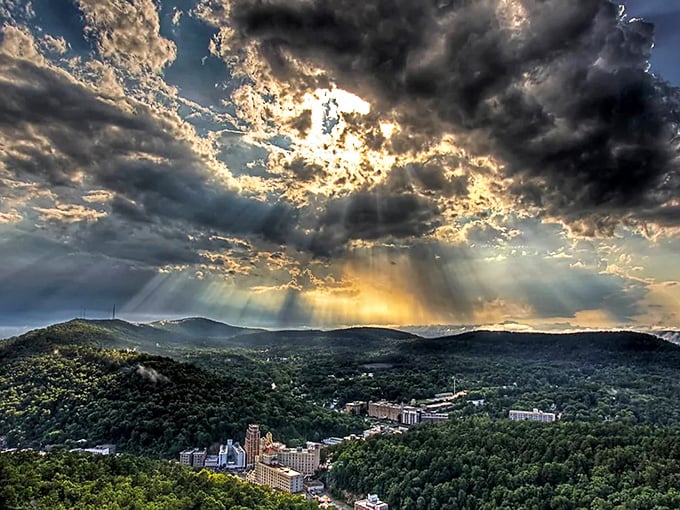Mother Nature showing off again! Those dramatic rays breaking through storm clouds over the mountains make even non-photographers reach for their phones.
