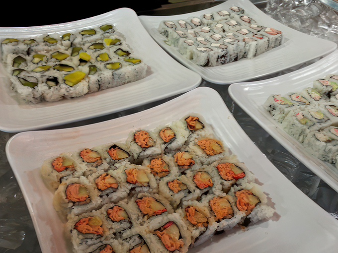 Sushi rolls lined up with military precision, each one a colorful ambassador from the land of perfect bite-sized meals.