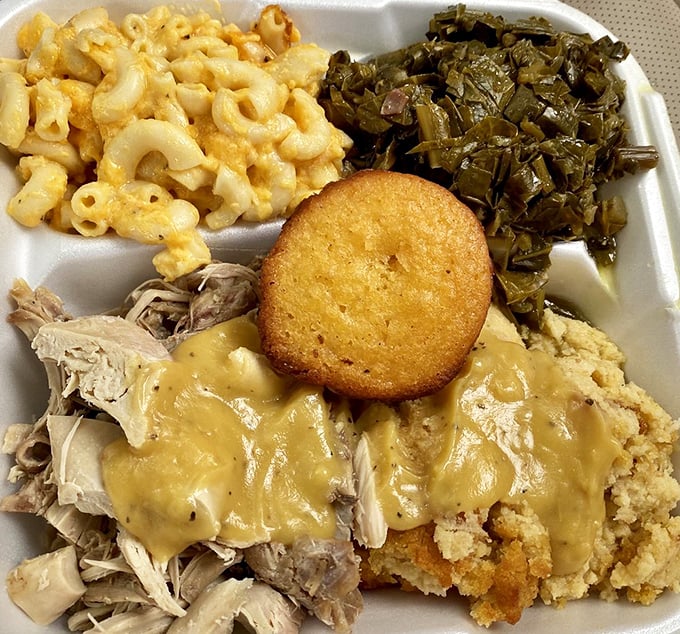 A Southern symphony on a plate: mac and cheese glowing like liquid gold, collards cooked to perfection, and cornbread that could make a preacher dance.