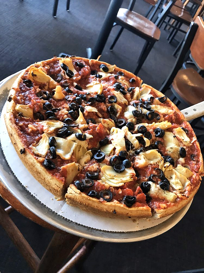 Black olives and artichoke hearts play starring roles in this veggie masterpiece. Proof that meatless doesn't mean flavorless in pizza paradise.