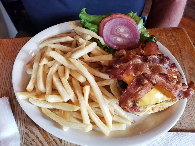 Bacon arranged like a crown atop melted cheese&mdash;because in the burger kingdom, this is royalty that doesn't require formal attire.